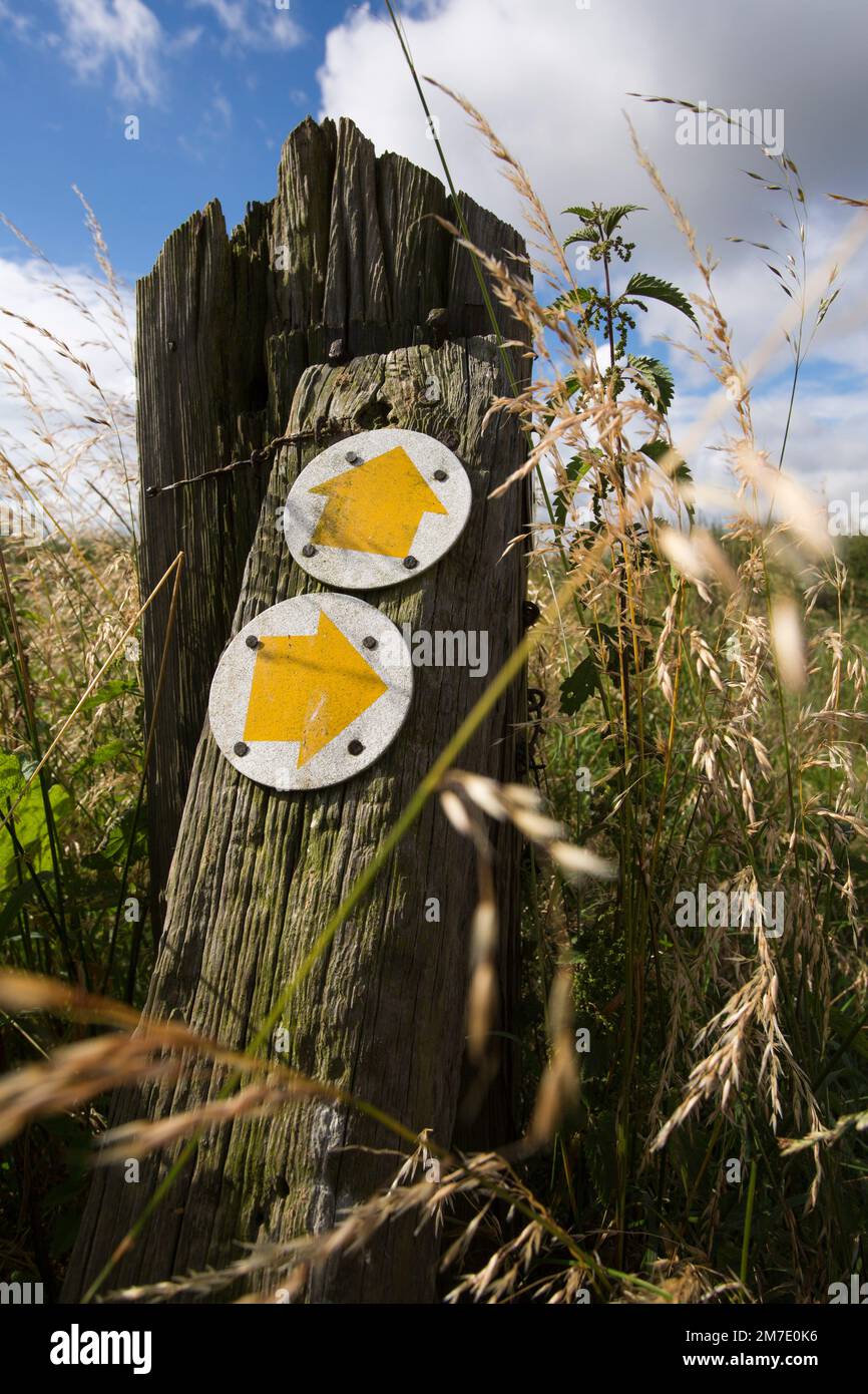 An old wodden post on the side of a footpath in the british countryside ...