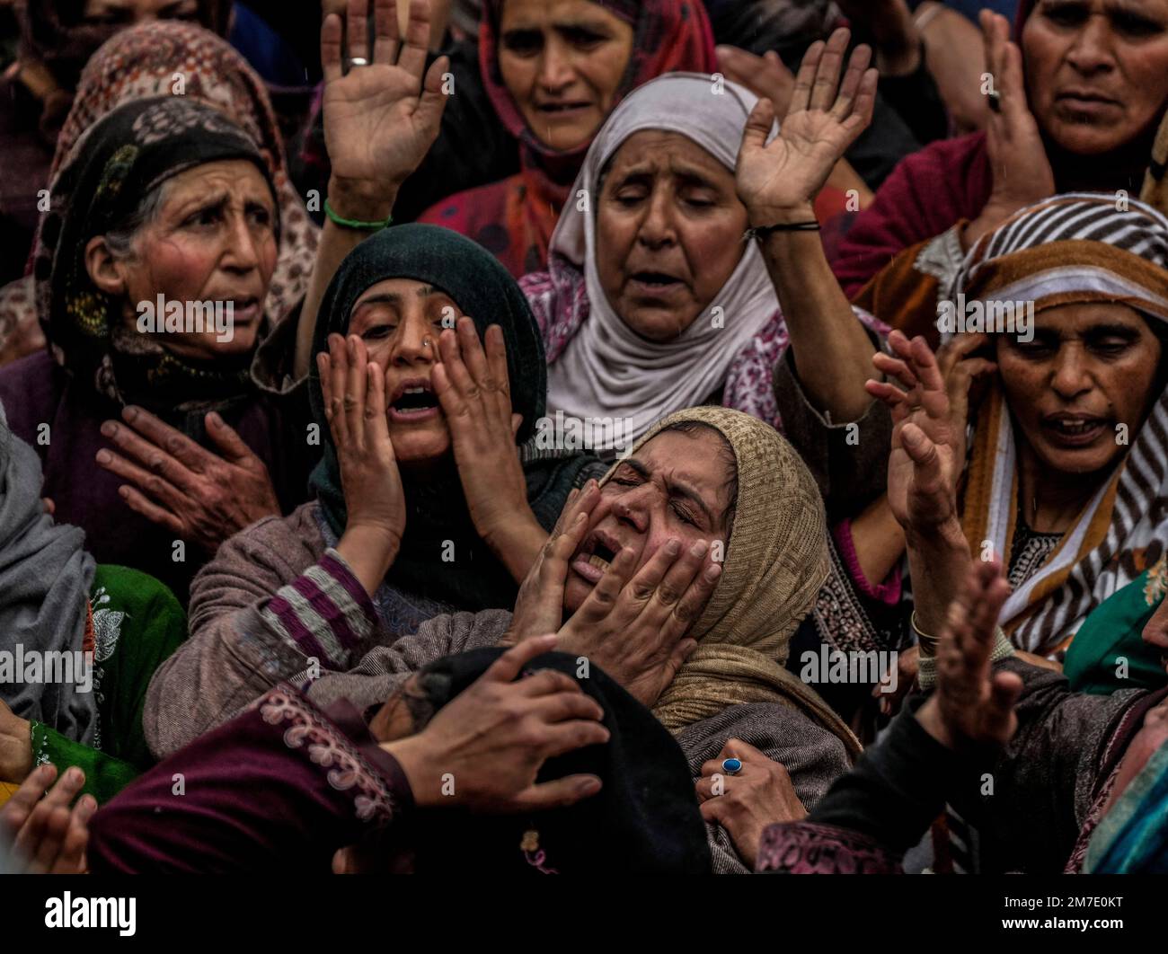 Family members and relatives mourn near the dead body of Rafia Nazir ...