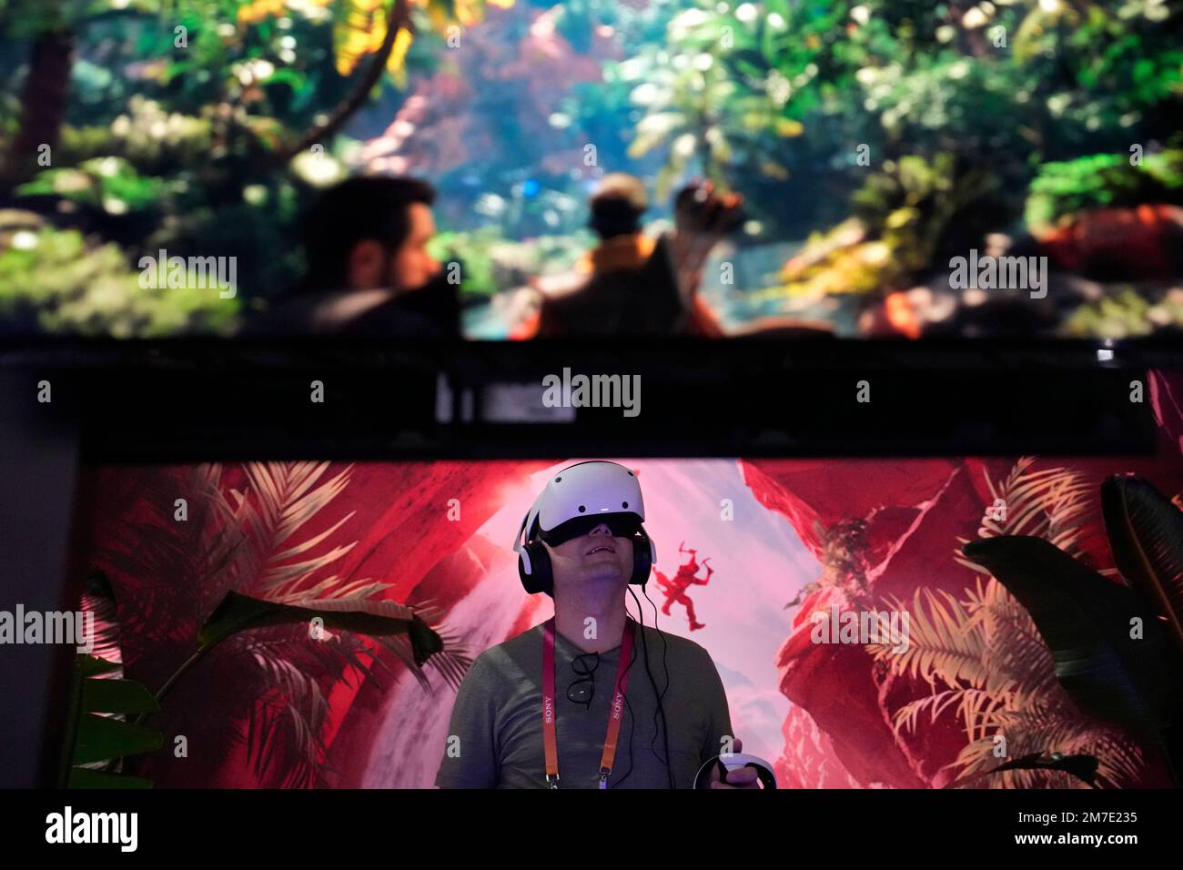 An attendee tries out the PlayStation VR 2 headset at the Sony booth ...