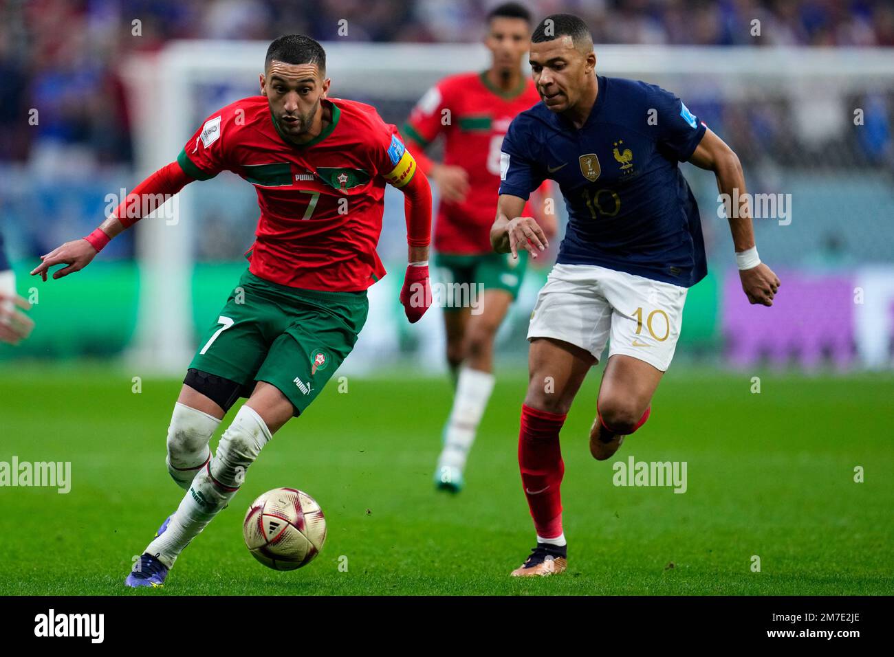 France's Kylian Mbappe, right, challenges Morocco's Hakim Ziyech during ...