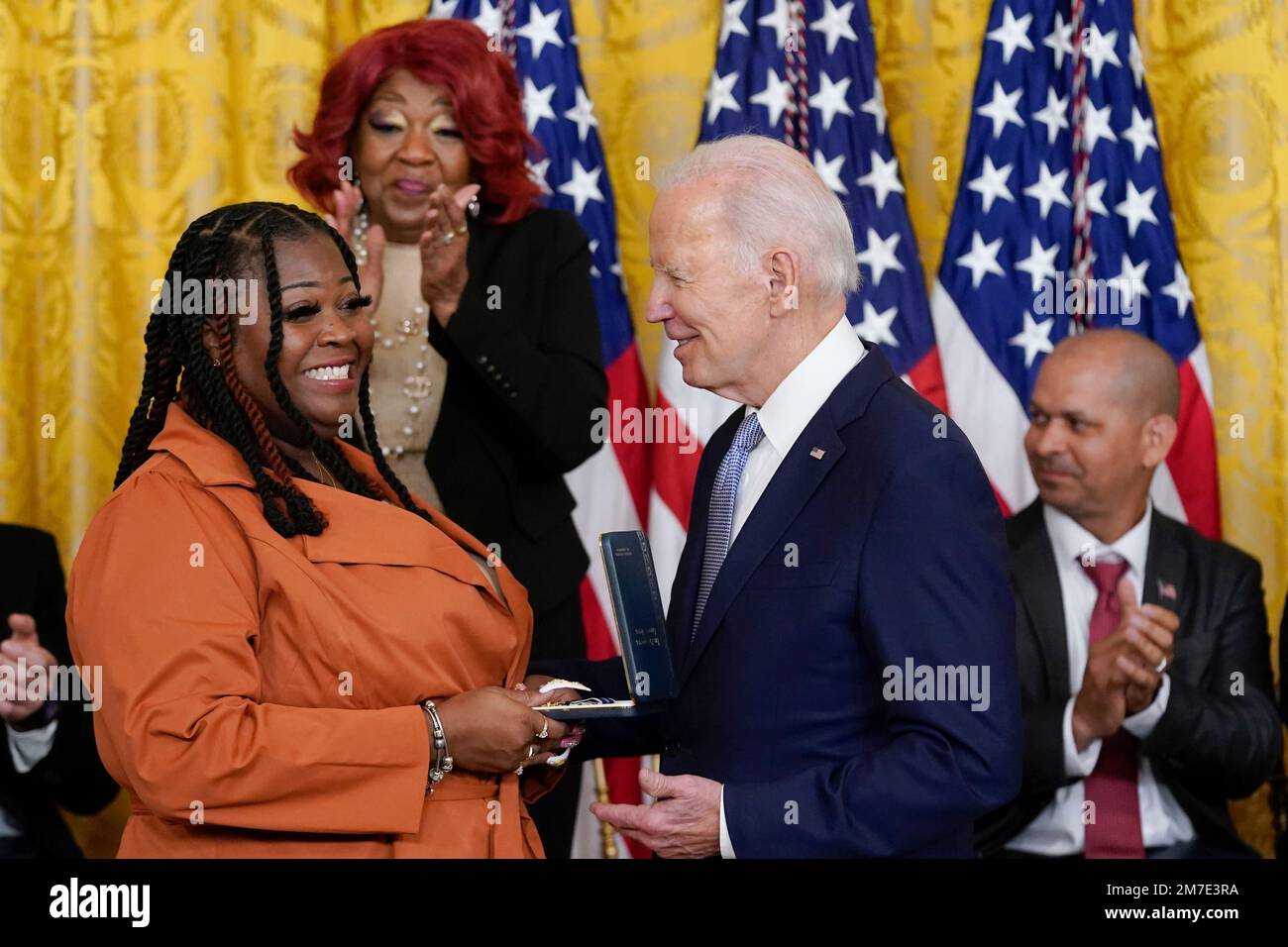 Ruby Freeman stands and applauds as President Joe Biden awards the ...