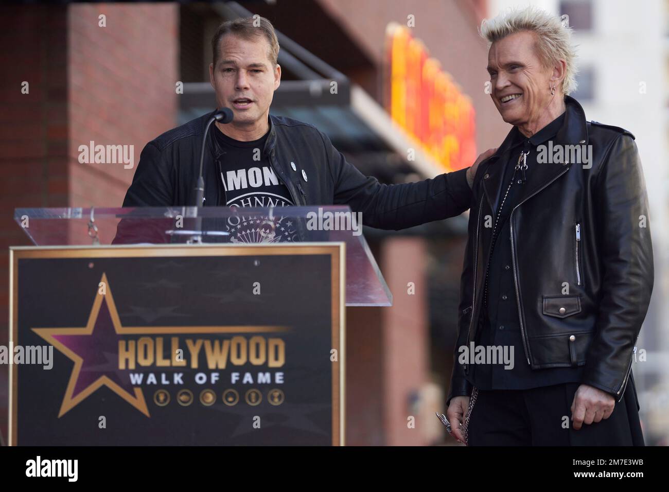 Guest speaker Shepard Fairey, left, address the crowd during a ceremony ...