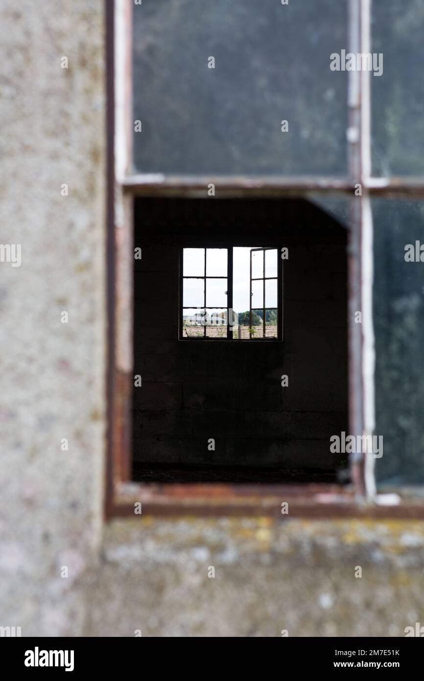 Old run down empty building with broken windows and dark spooky ...
