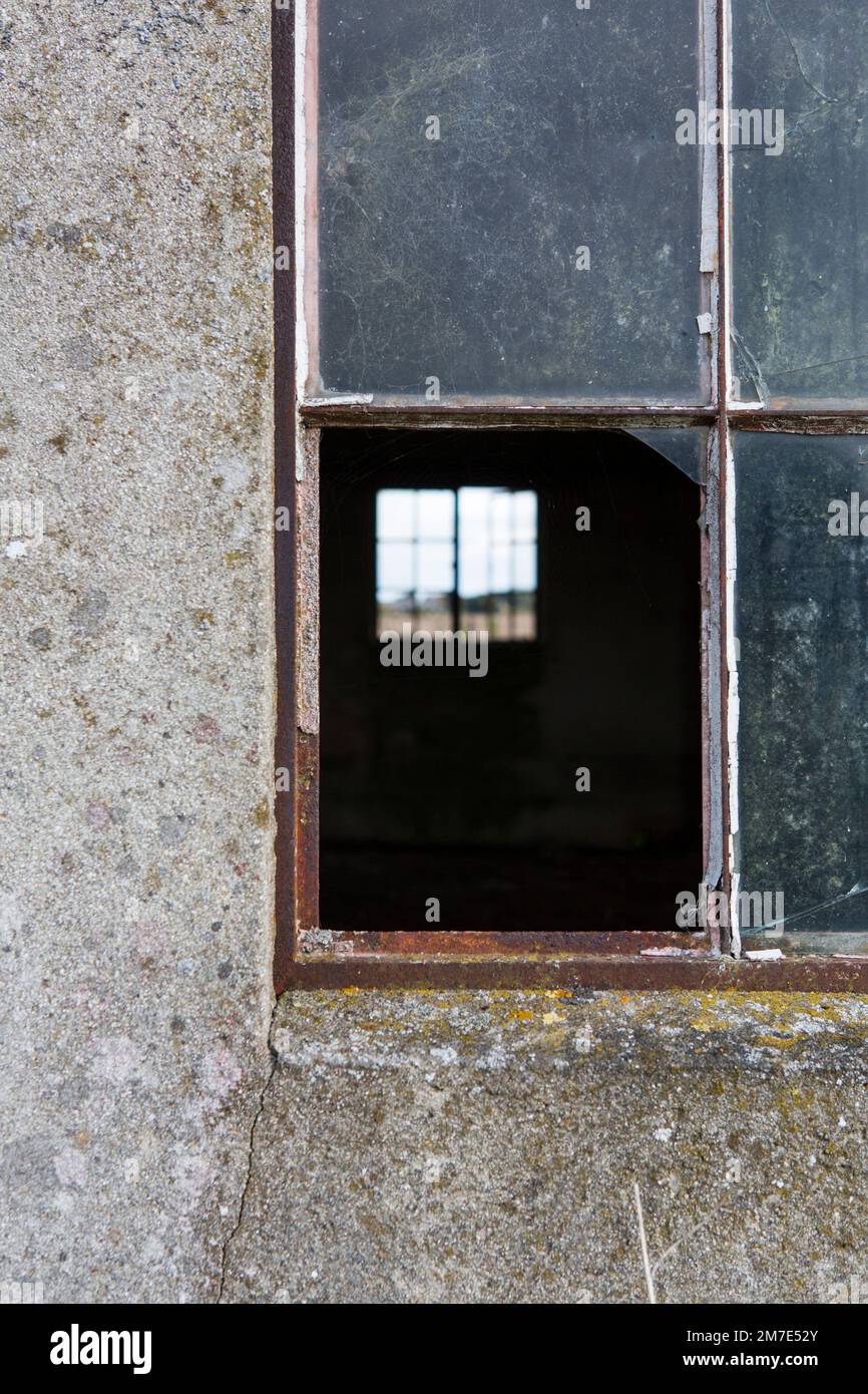 Old run down empty building with broken windows and dark spooky ...