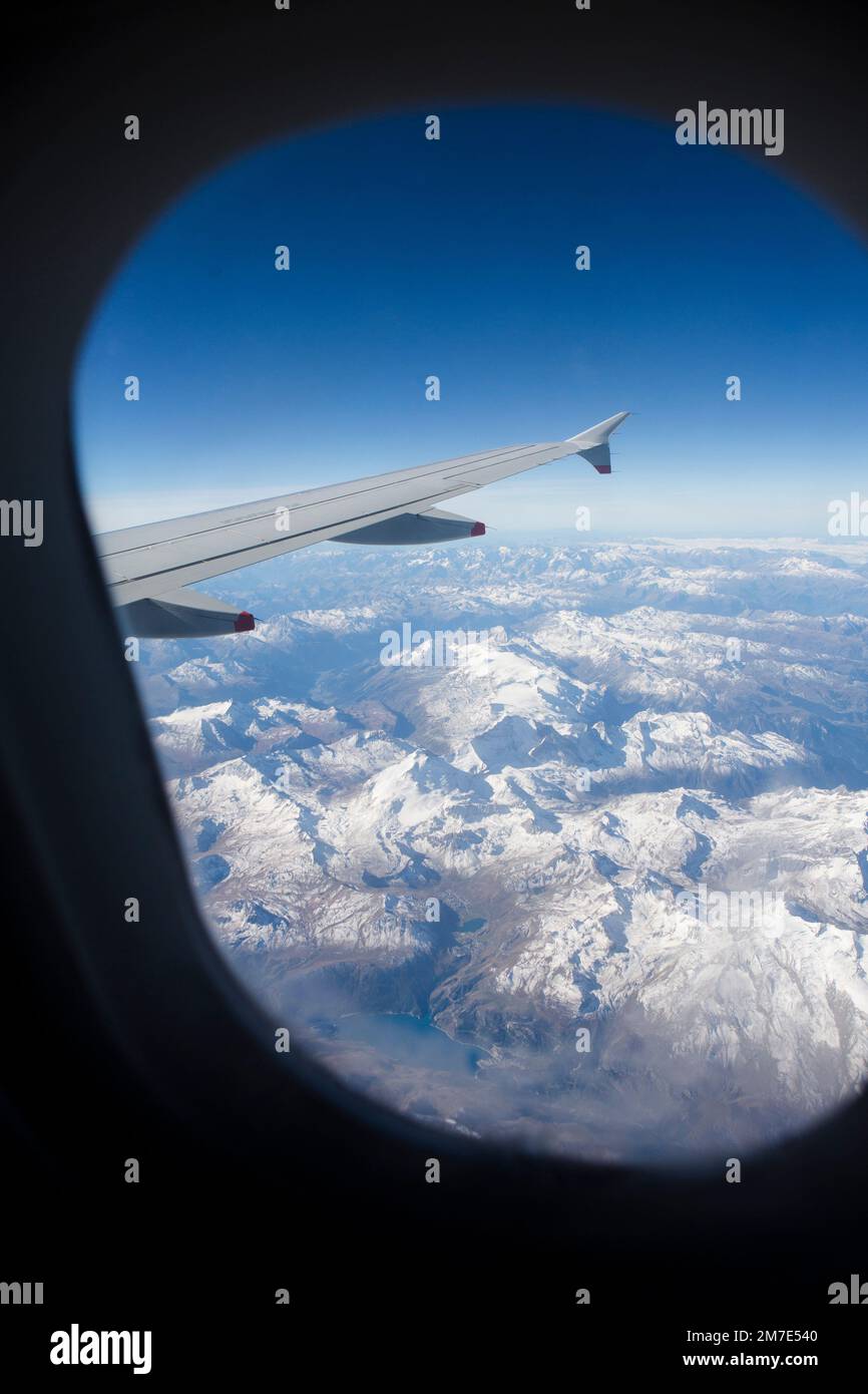 view from an aircraft window flying over the Alps towards Italy Stock ...