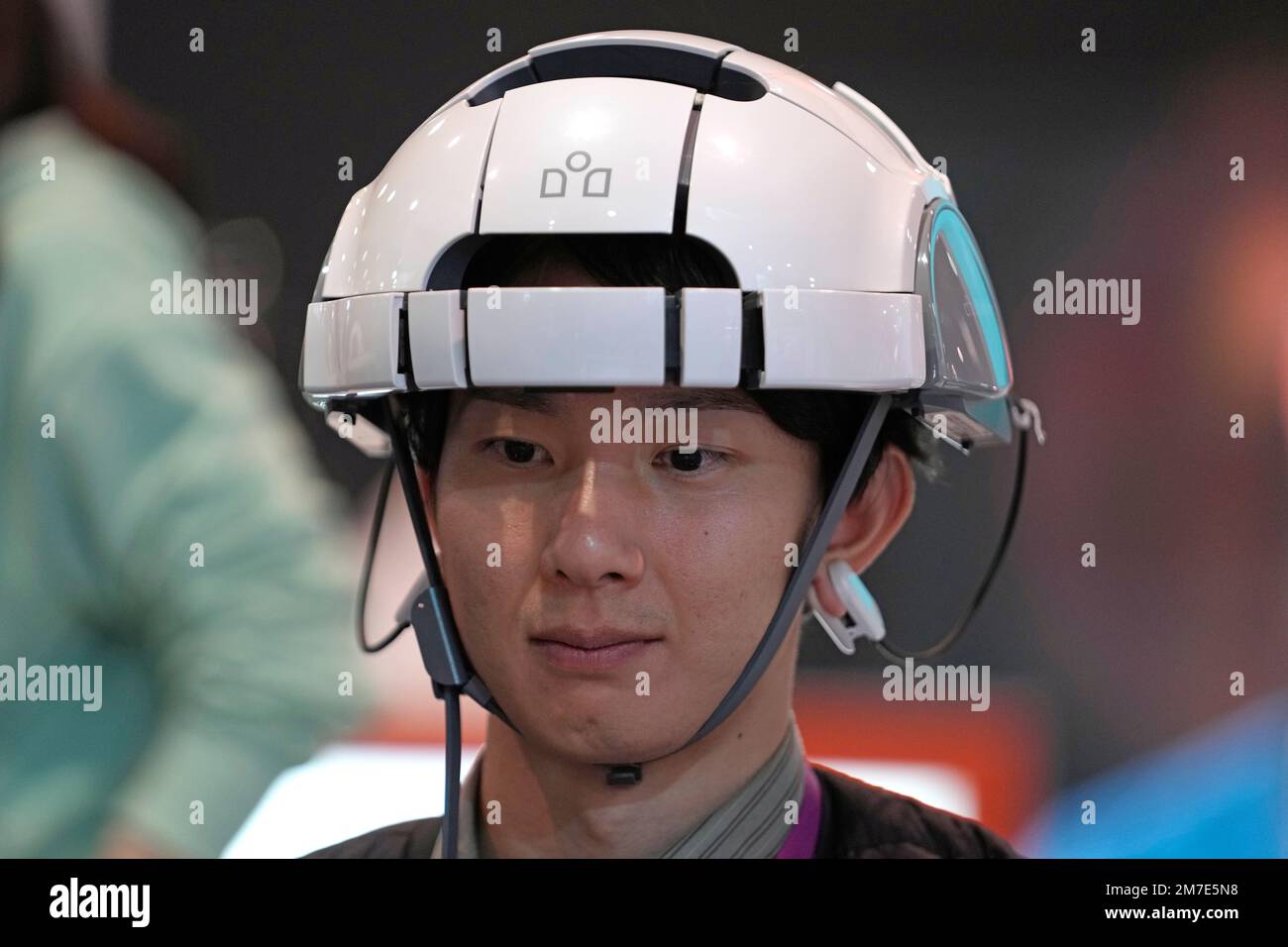 A CES attendee wears an iSync Wave EEG helmet at the iMediSync booth ...