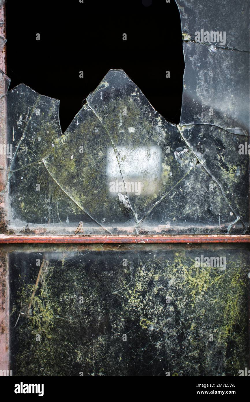 Old run down empty building with broken windows and dark spooky ...