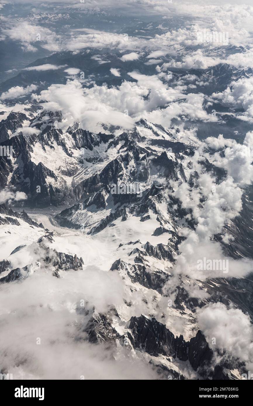 Thin wispy cloud covers The Alps mountin range as seen from an ...