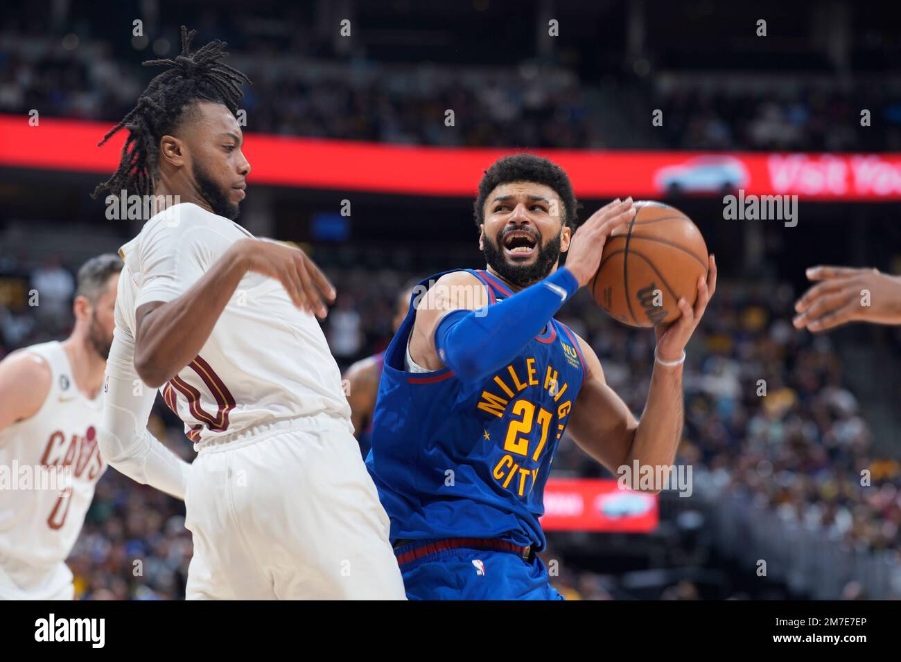 Denver Nuggets guard Jamal Murray, right, drives to the basket as ...