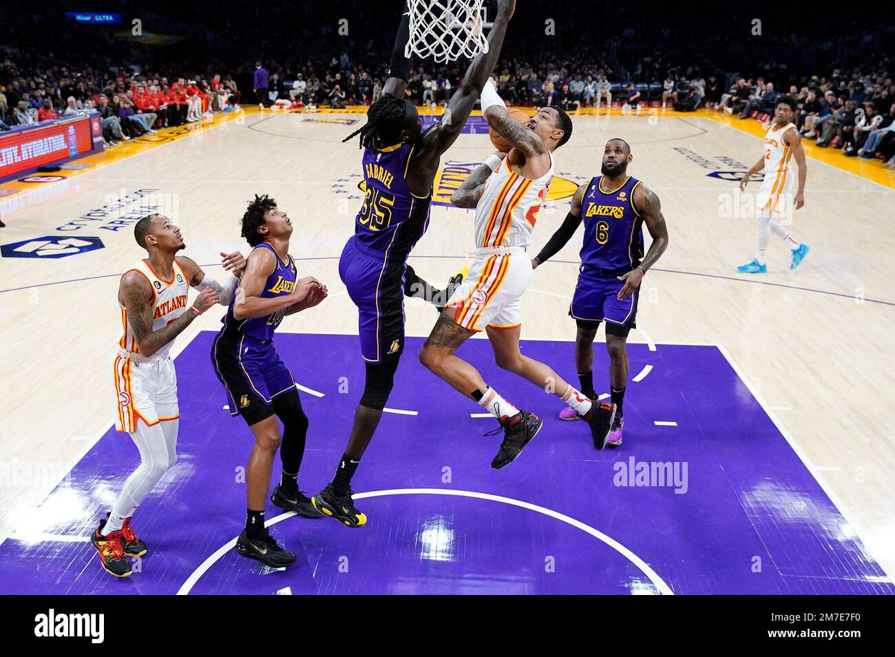 Atlanta Hawks' John Collins, center right, shoots under pressure from ...