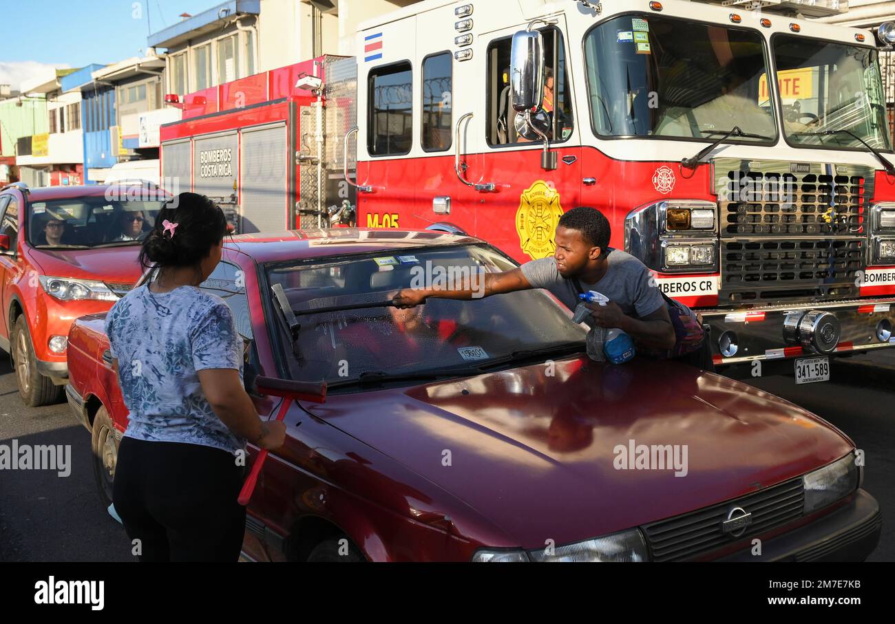 Venezuelan migrants Richard Plaza and his wife Widner Bijarena wash windshields on a street in ...