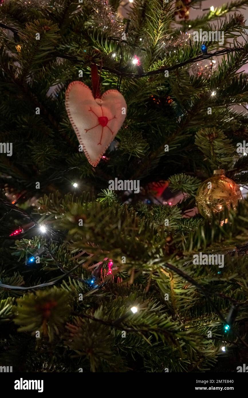 Christmas decorations including a material heart hanging on a christmas ...