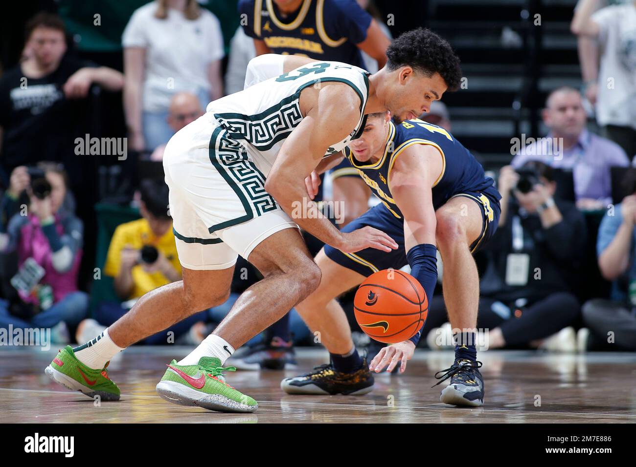 Michigan's Joey Baker, right, tries for a steal against Michigan State ...