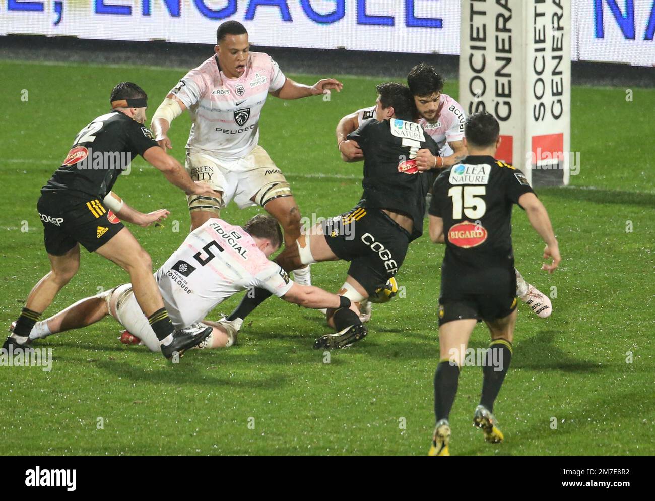 Paul Boudehent of Stade Rochelais is tackled by Joshua Brennan and ...