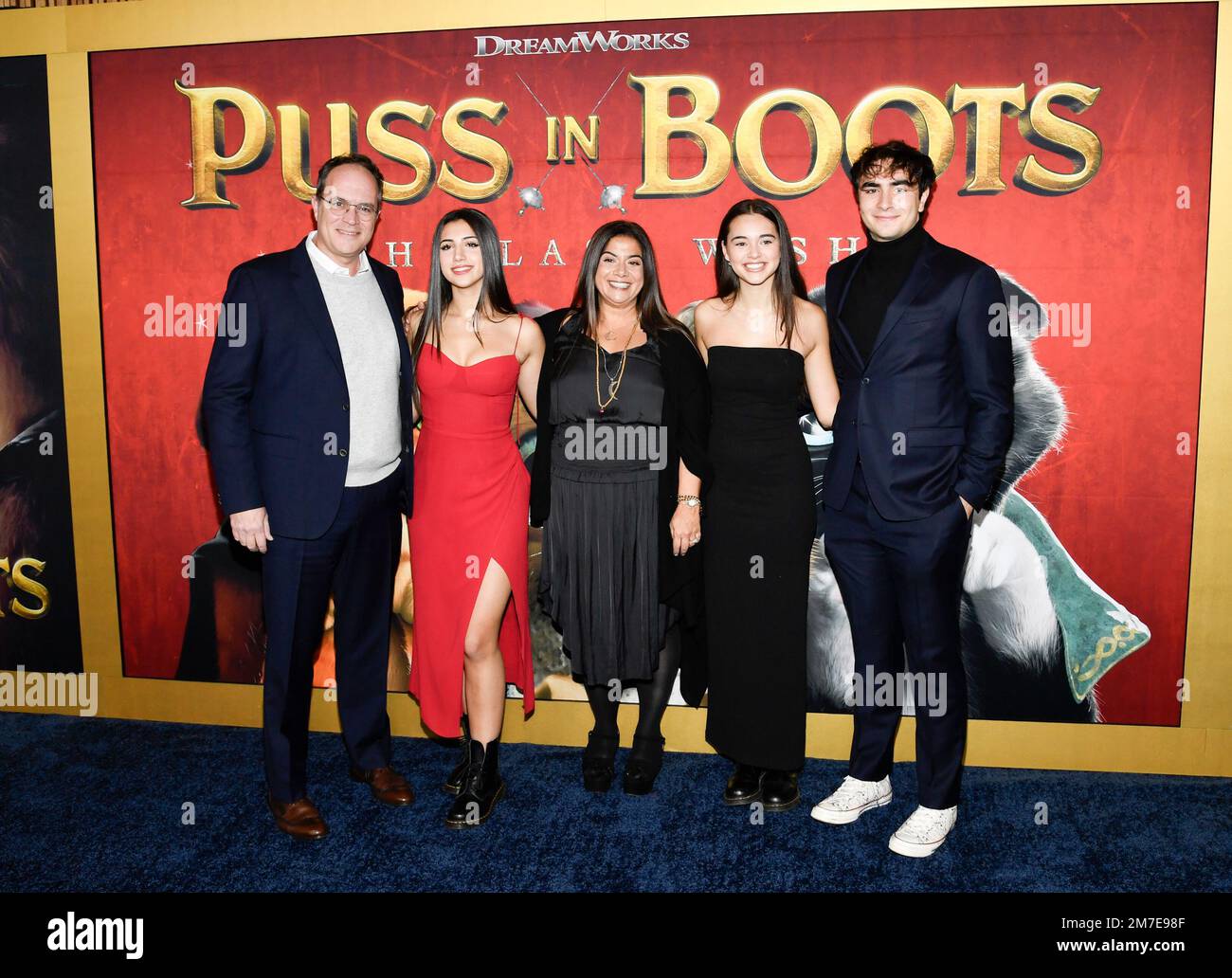 Screenwriter Tom Wheeler, left, and family attend the premiere of "Puss ...