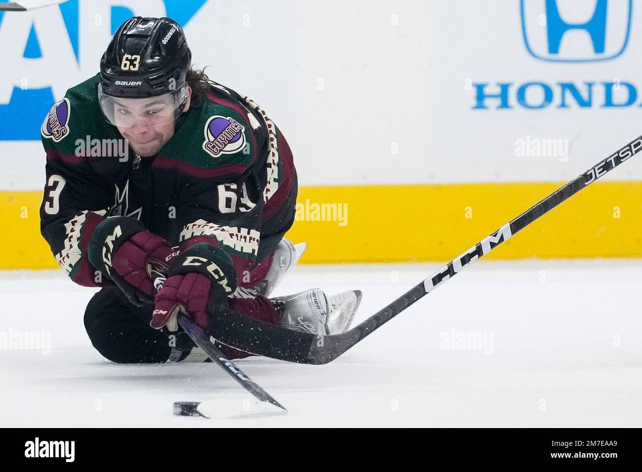 Arizona Coyotes left wing Matias Maccelli (63) dives for the puck ...