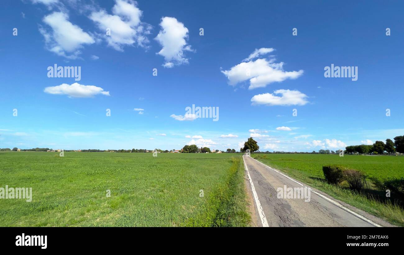 Rural landscape cultivated field with farm house Stock Photo - Alamy