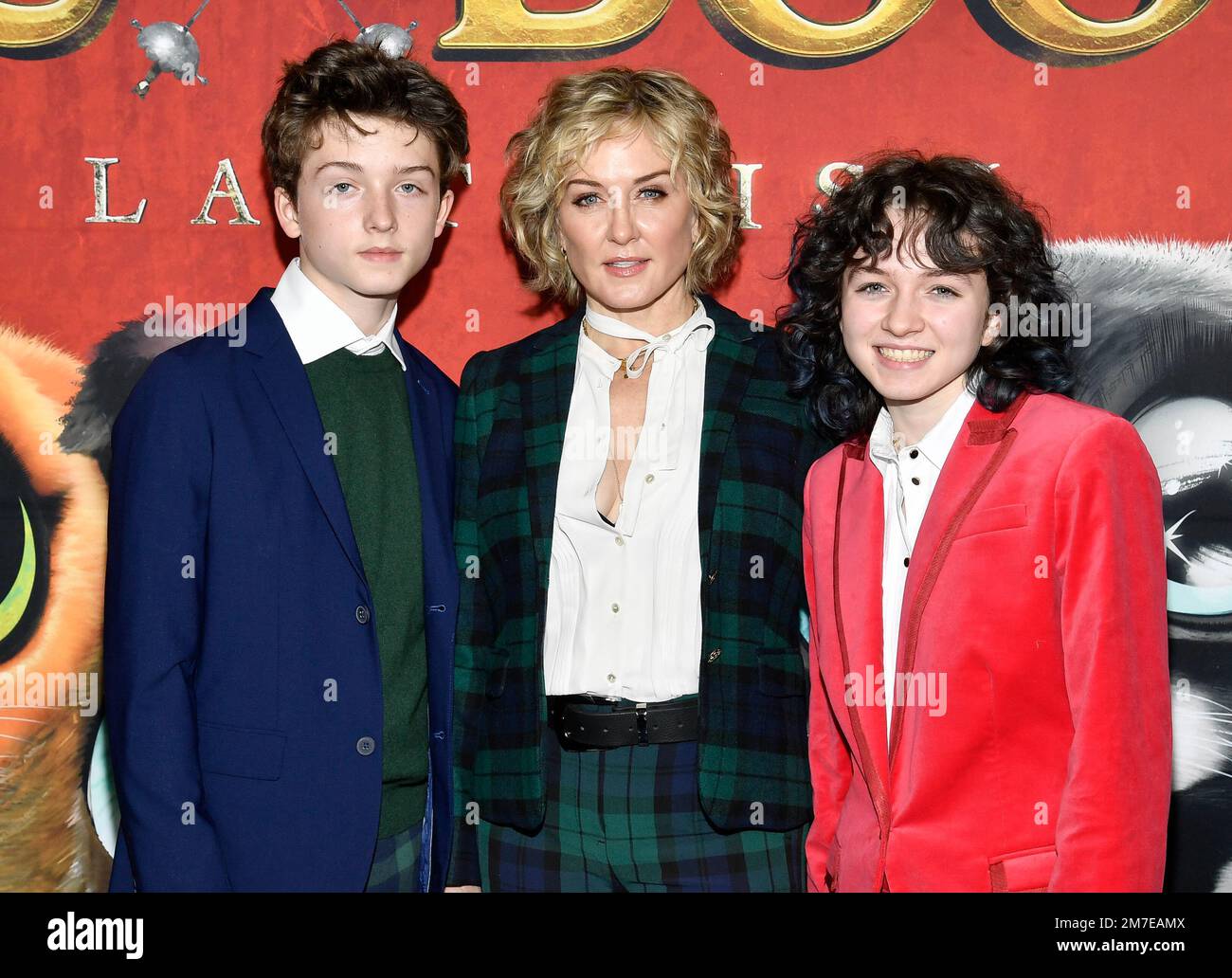 Amy Carlson, center, poses with her children Nigel Butler, left, and ...