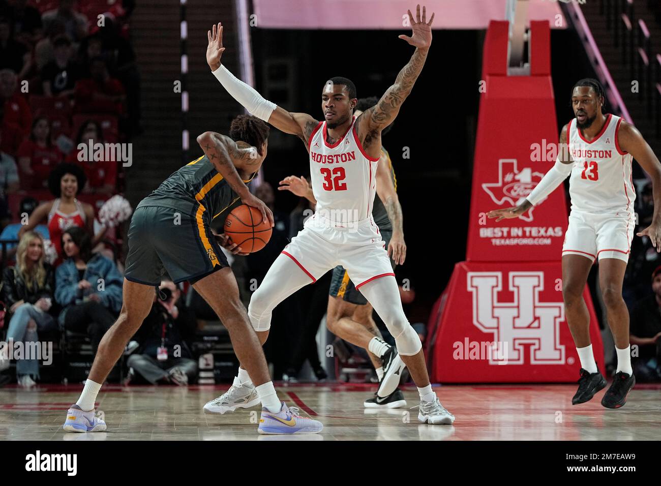 Houston forward Reggie Chaney (32), right, defends North Carolina A&T ...