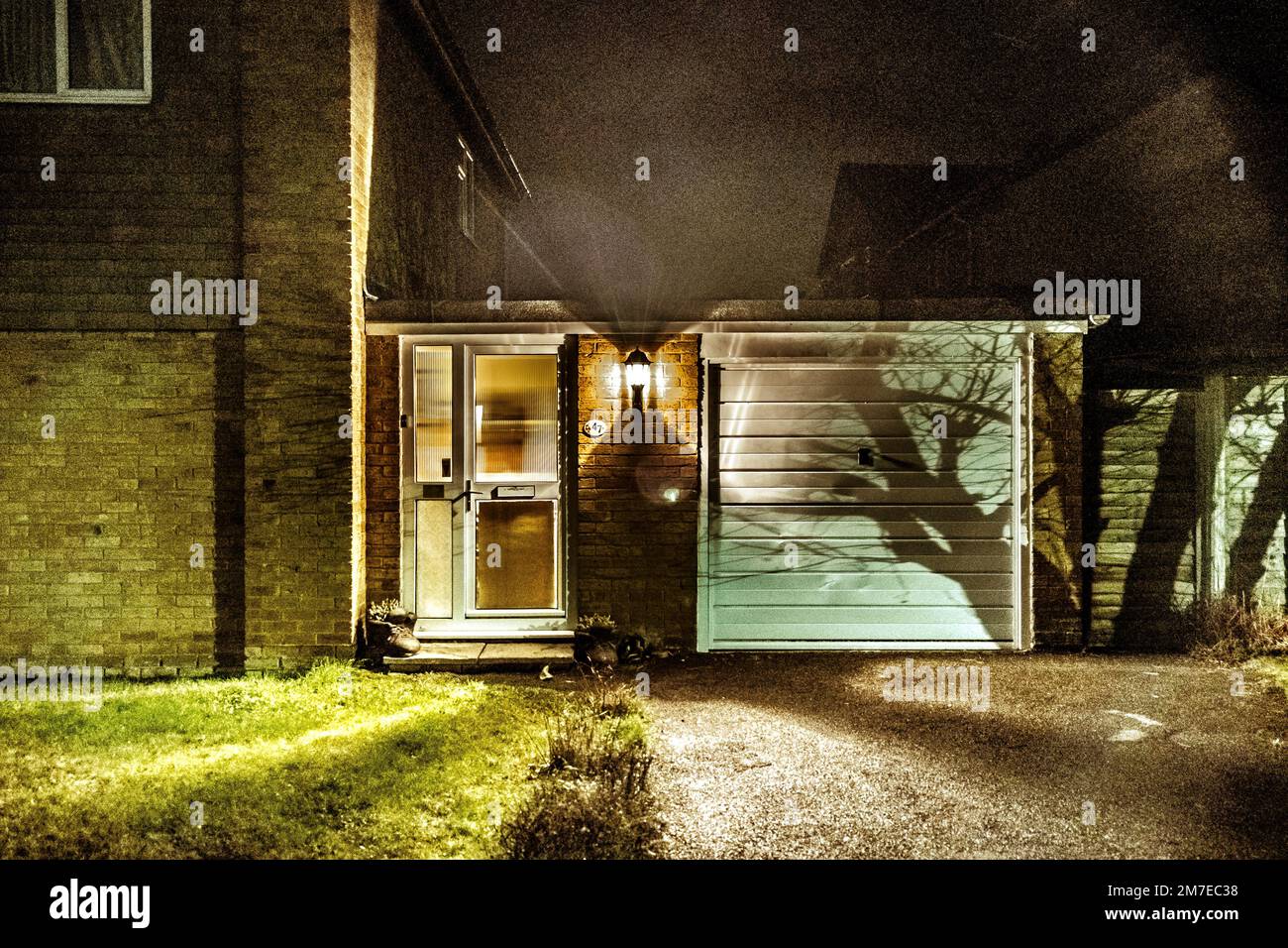 A modern hosuing estate with house and garage at night in an artsitic ...