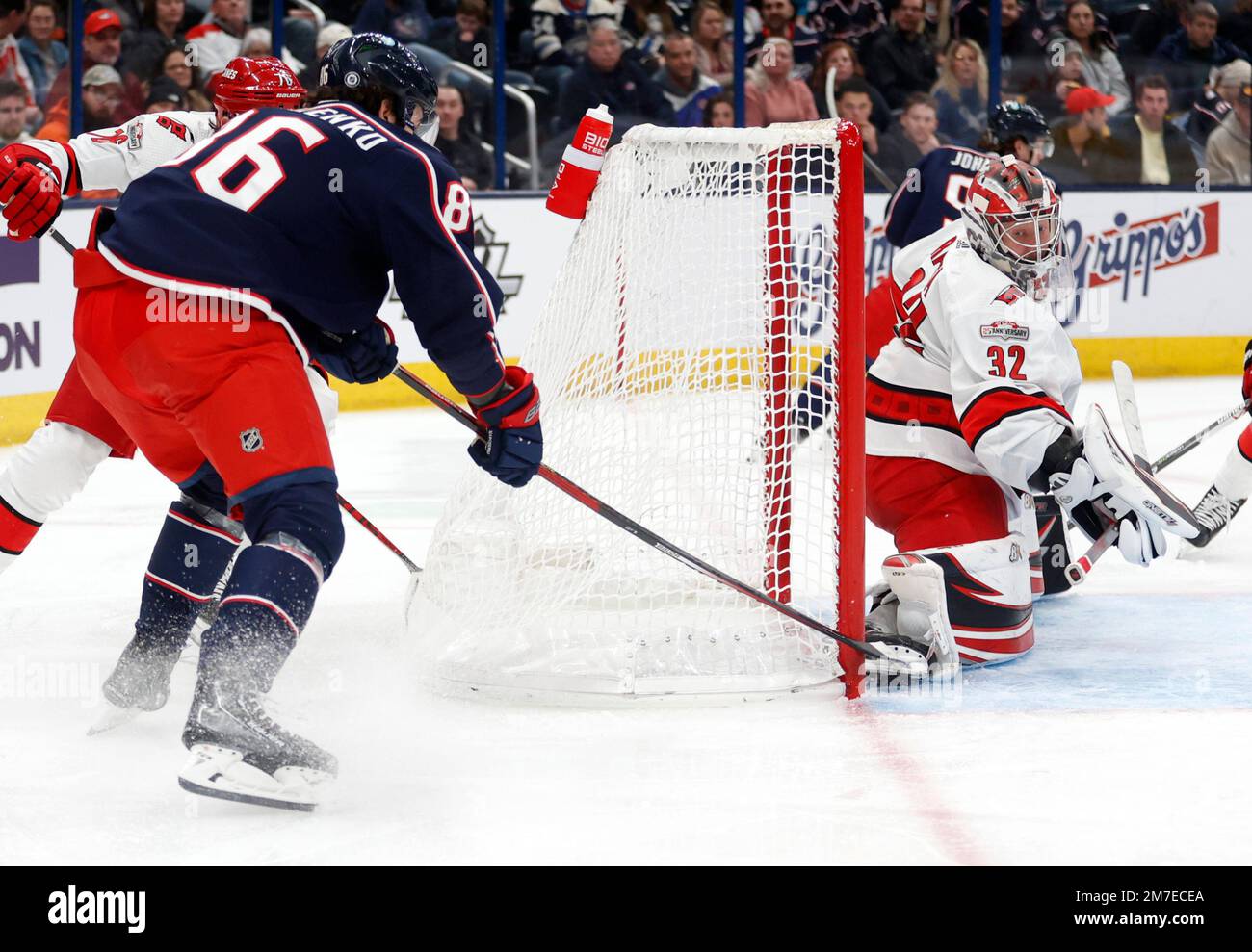 Columbus Blue Jackets forward Kirill Marchenko, left, scores behind ...