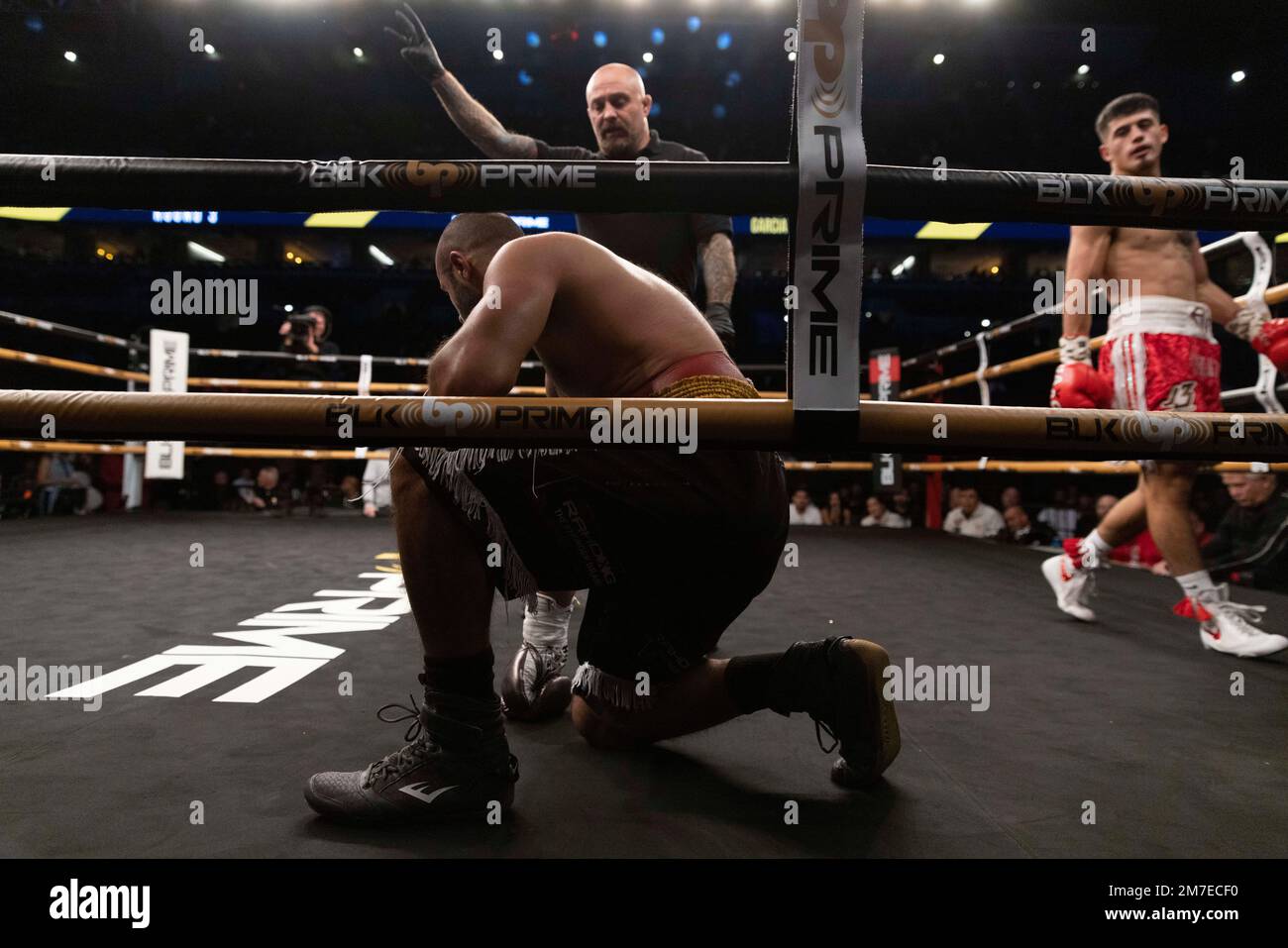Eduardo Pereira, left, kneels after a hard hit from Alan Garcia during ...