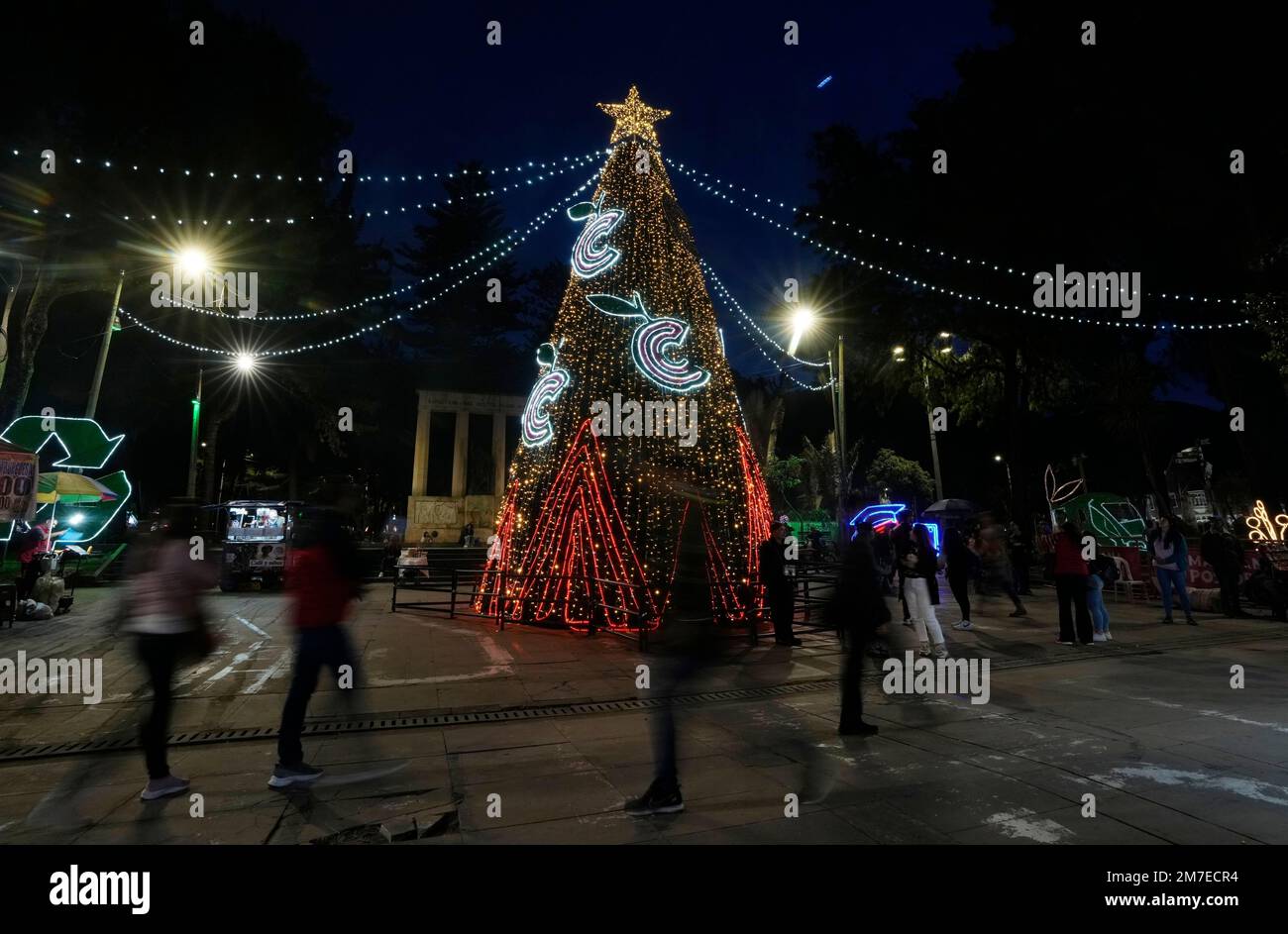 People walk among the Christmas lights that decorate the National Park ...
