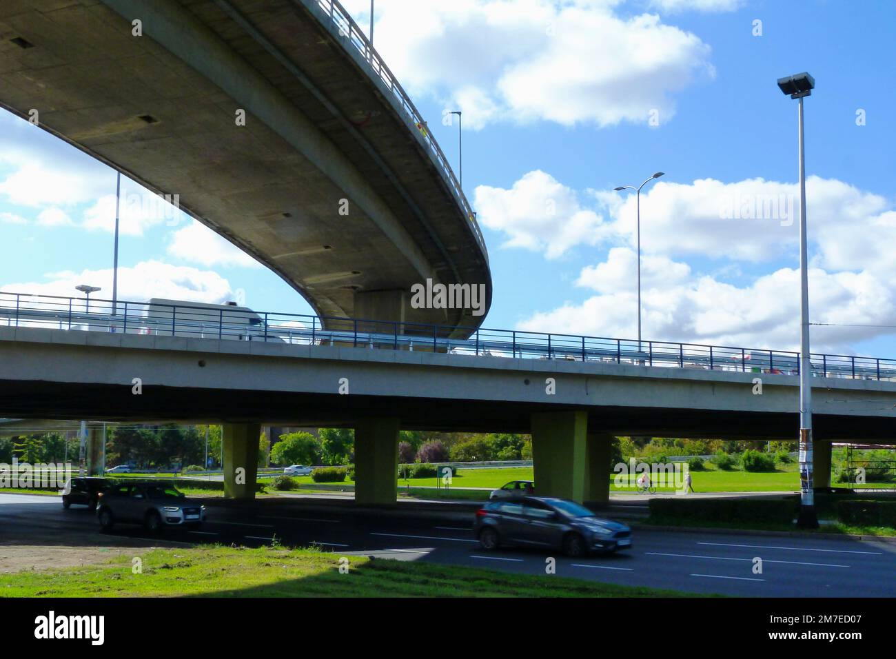 concrete overpass highway underside view. curving high speed road ...