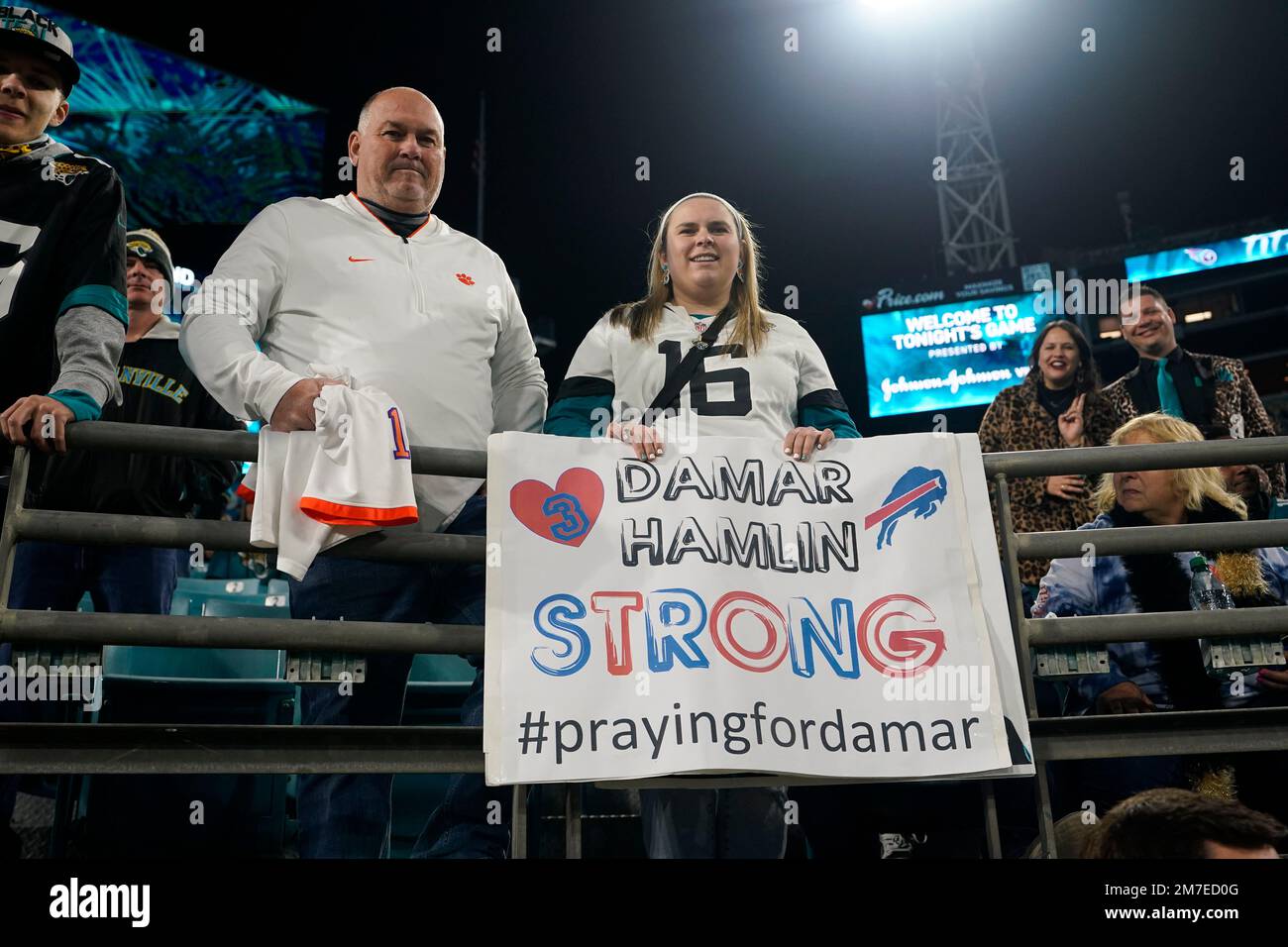 Fans display a sign honoring injured Buffalo Bills player Damar Hamlin ...
