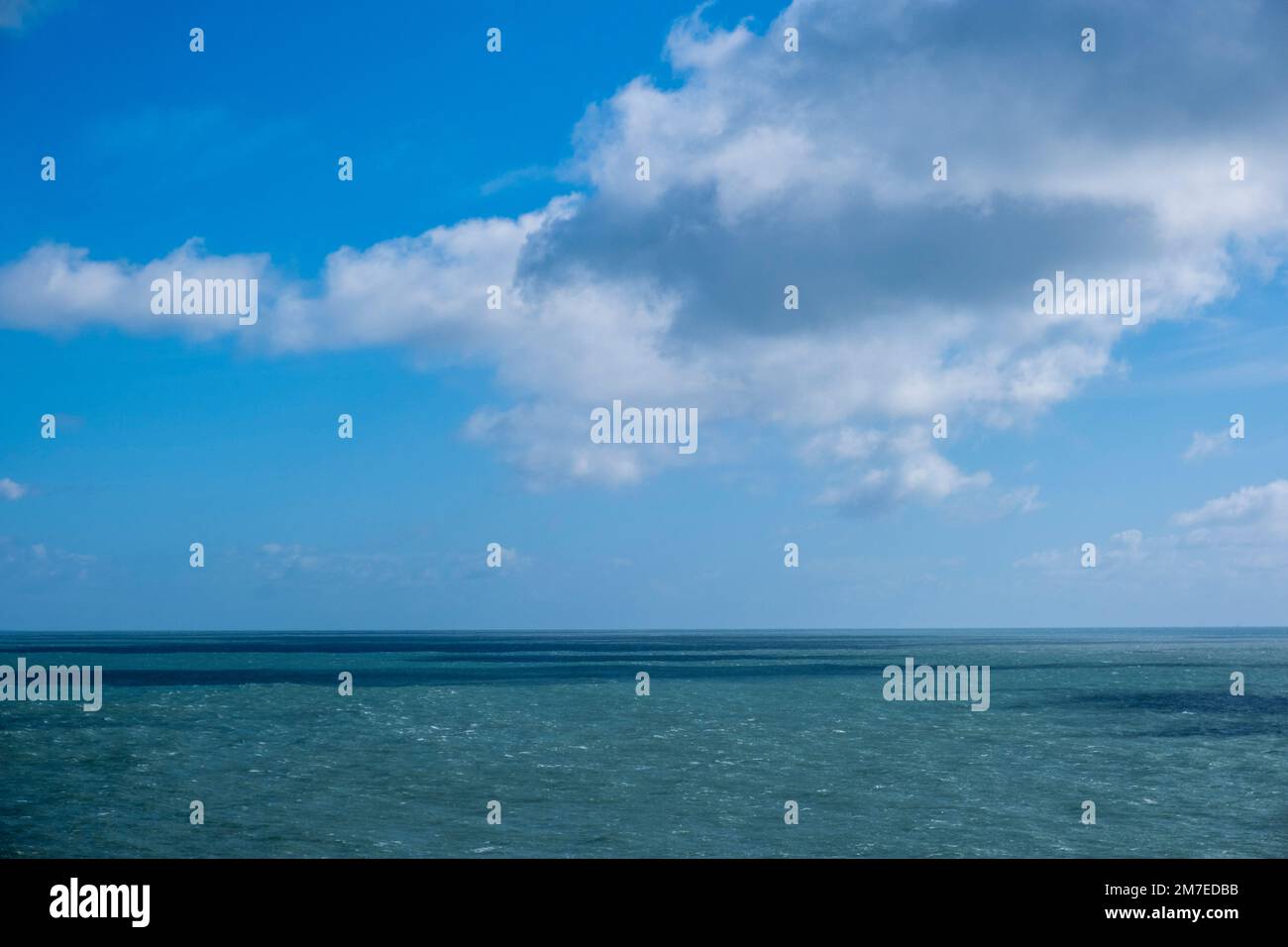 Clouds over the sea, lit by the sun in delicate shades of pastel colour ...
