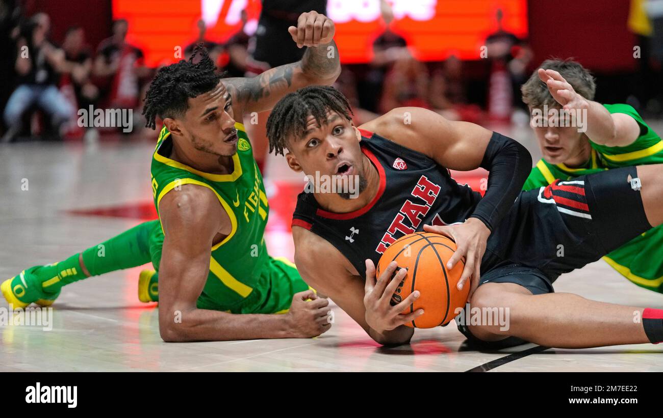 Utah guard Wilguens Exacte Jr., center, grabs the ball next to Oregon ...