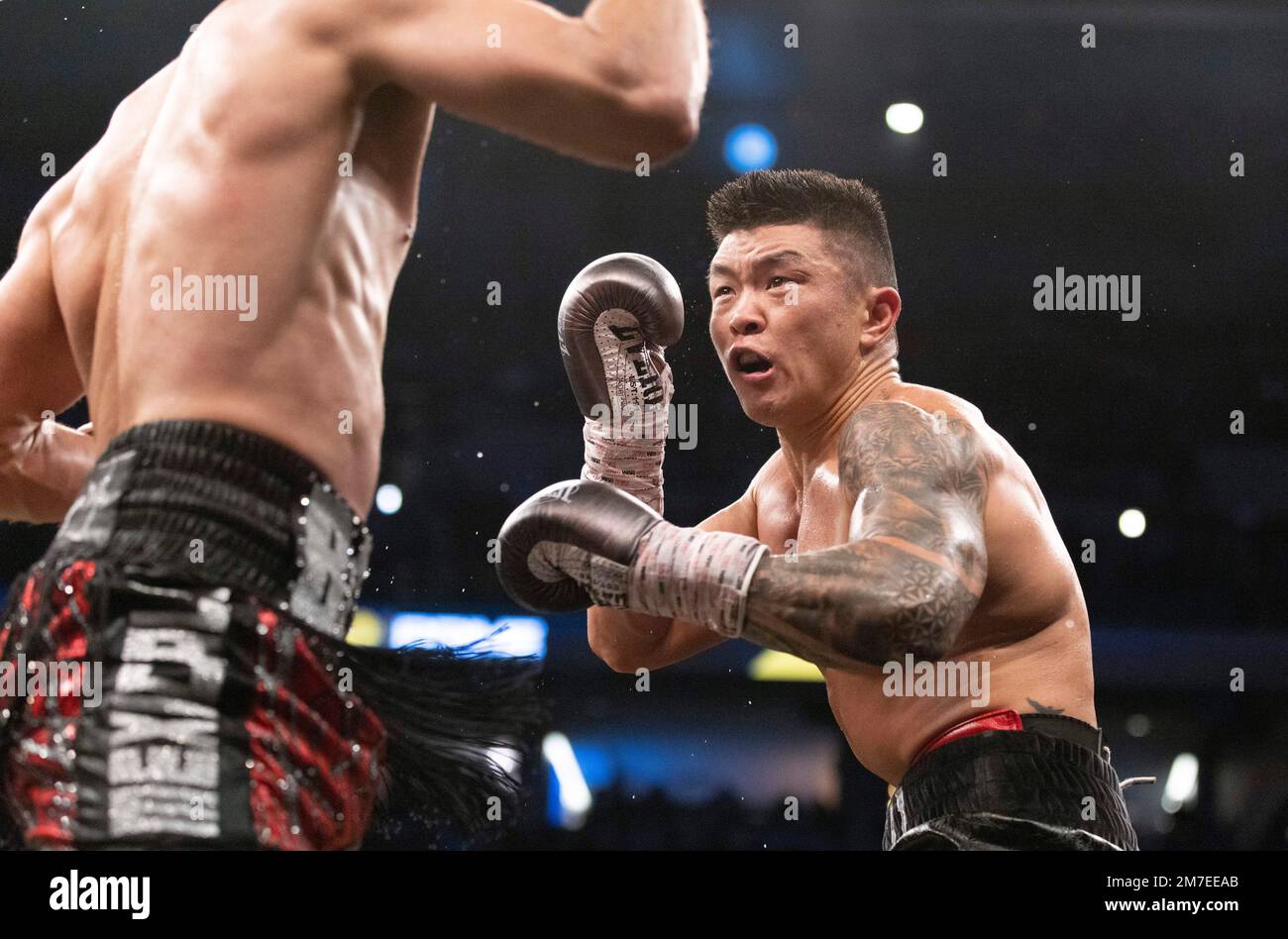 Arnold Khegai, right, fights Eduardo Baez during a featherweight boxing match on Saturday, Dec ...