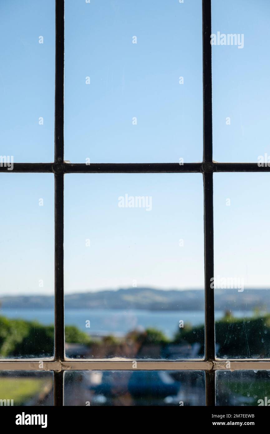 Lookigng out of a leaded window across the bay to the horizon beyond ...