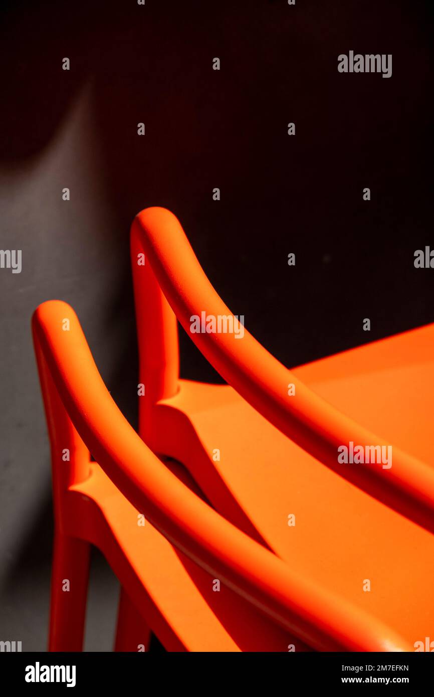 A stack of two red plastic chairs Stock Photo - Alamy