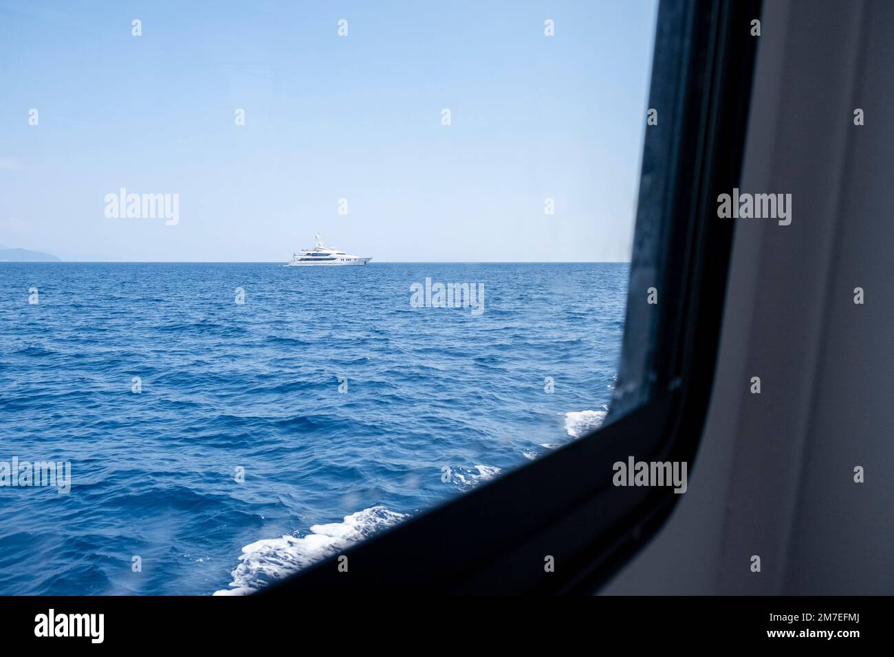 Looking out of the window of a tourist boat at the sea with a motor ...