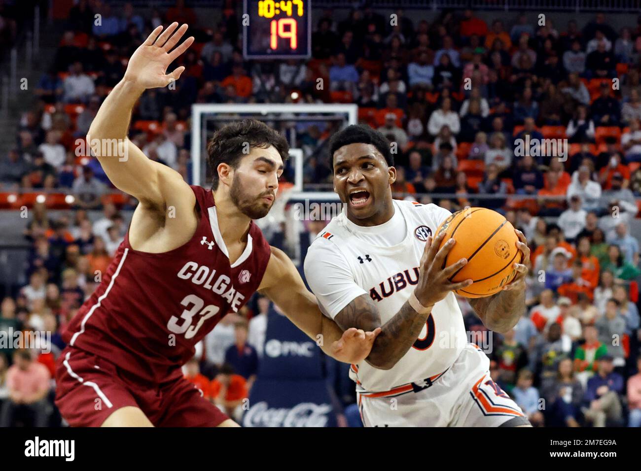 Auburn guard K.D. Johnson (0) drives to the basket as Colgate guard ...