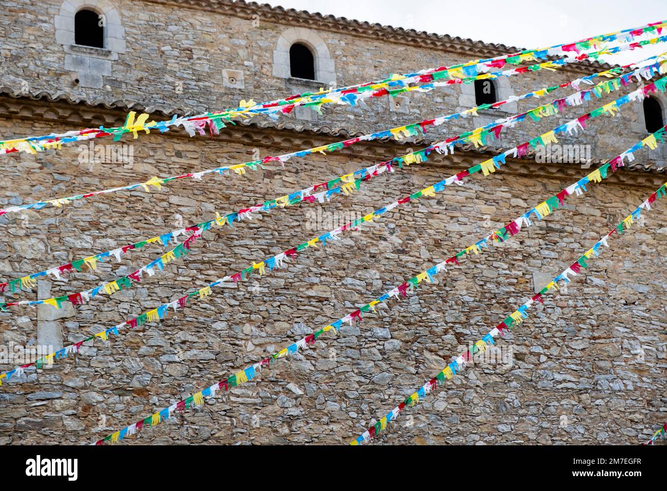 Coloured flags and bunting hanging from a building in Spain Stock Photo ...