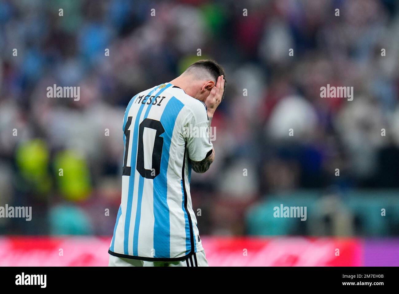 Argentina's Lionel Messi cover his face after beating Croatia 3-0 in a ...