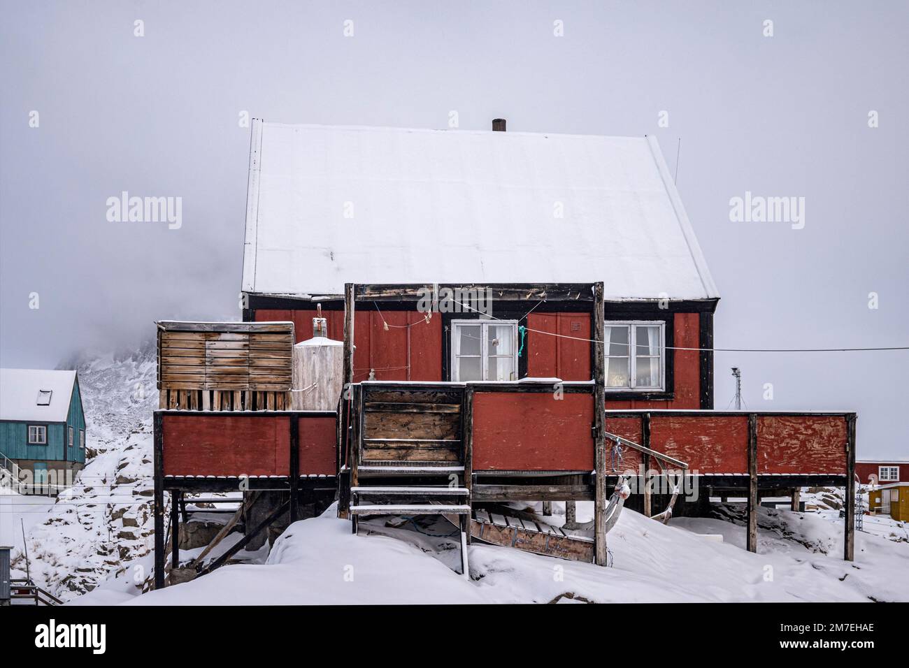 Colourful houses clinging to the mountain side in Uummannaq town, west ...