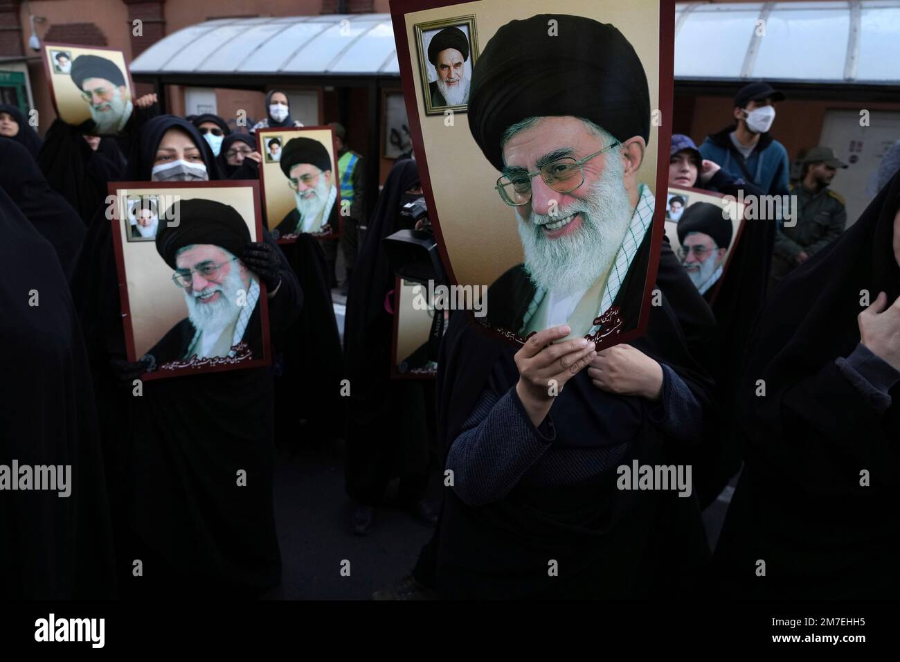 Iranian demonstrators hold posters showing portraits of the Supreme ...