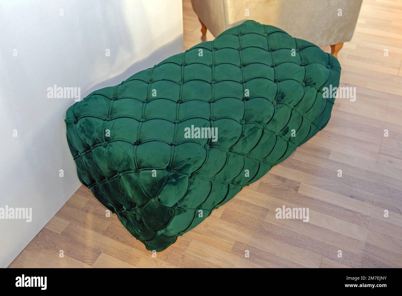 Tufted Green Plush Ottoman at Laminate Floor Room Stock Photo - Alamy