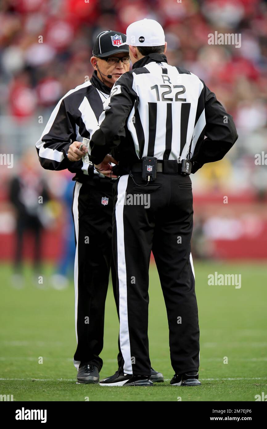 Field judge Rick Patterson (15) and referee Brad Allen (122) talk ...