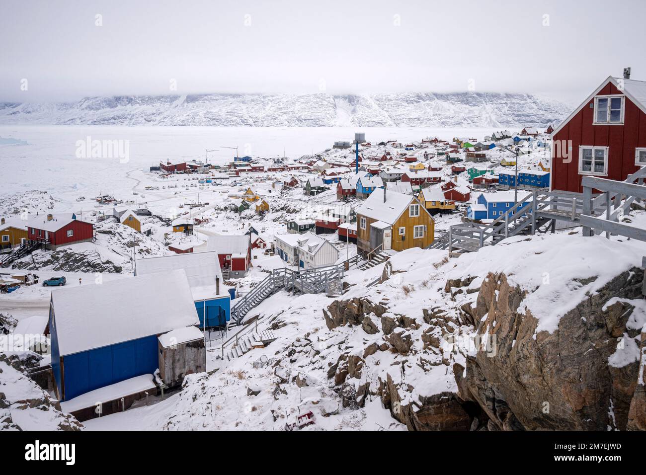 Colourful houses clinging to the mountain side in Uummannaq town, west ...