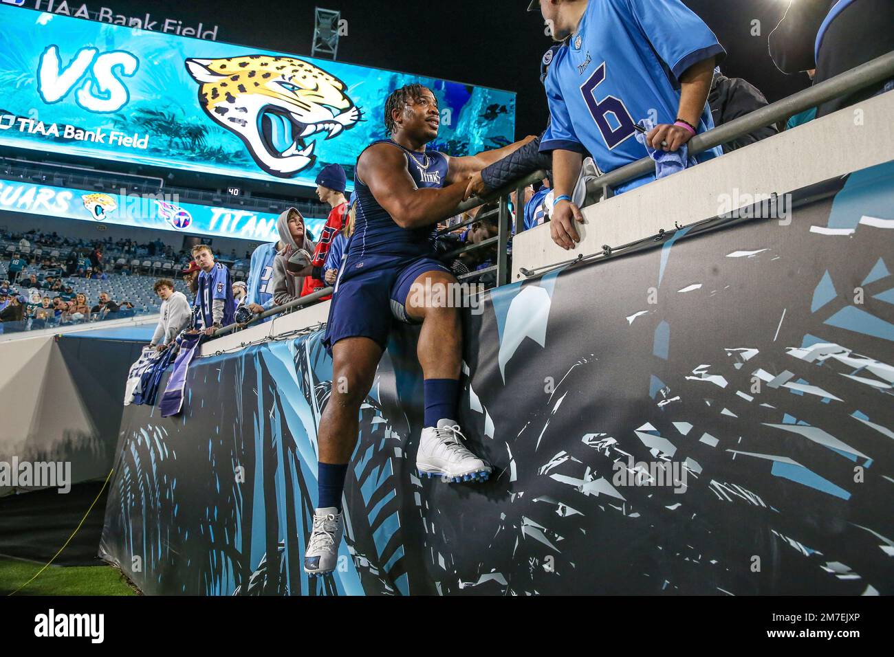 Tennessee Titans defensive end DeMarcus Walker (95) greets family ...