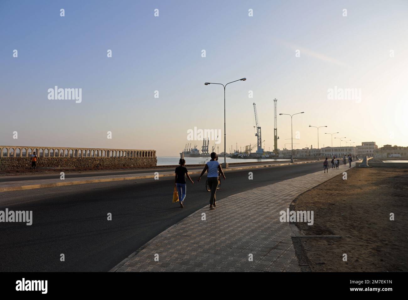 People walking to work along the causeway at daybreak in Massawa Stock ...