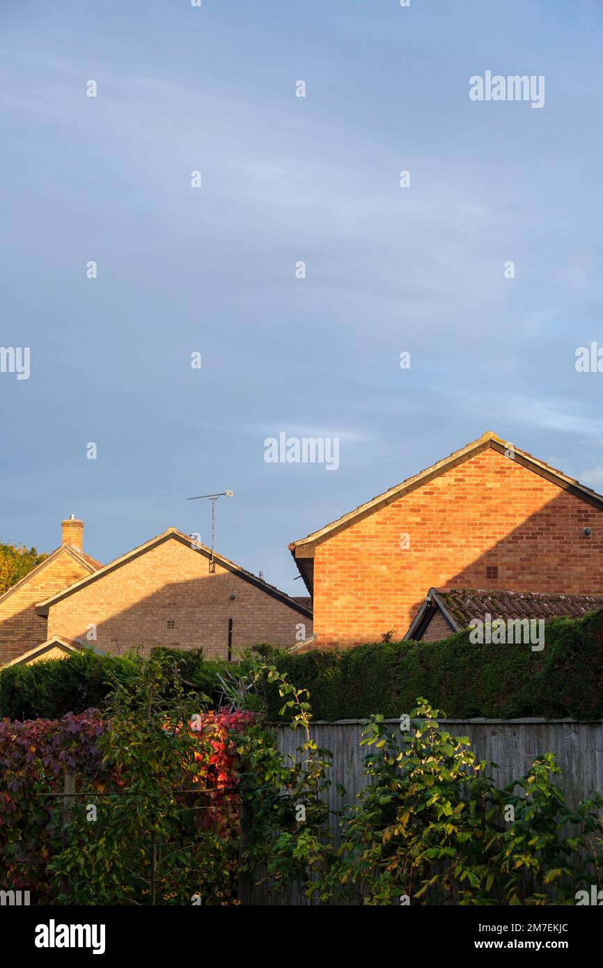 The side of brick built houses in the sunshine on a housing estate in ...