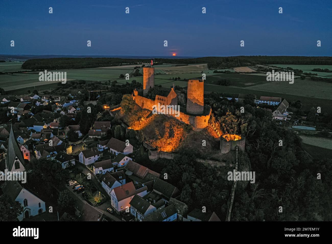 Image of illuminated Muenzenberg castle ruins in Germany in the evening ...