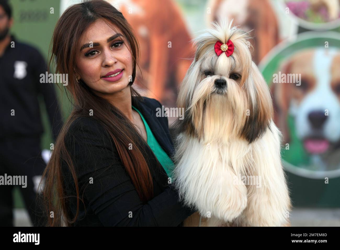 A Pakistani woman poses with her dog during a dog show, organized by ...