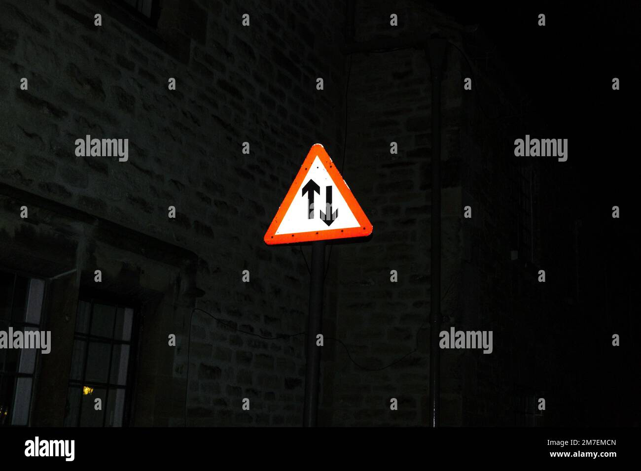 Road signs illuminated in the night by camera flash and reflecting ...
