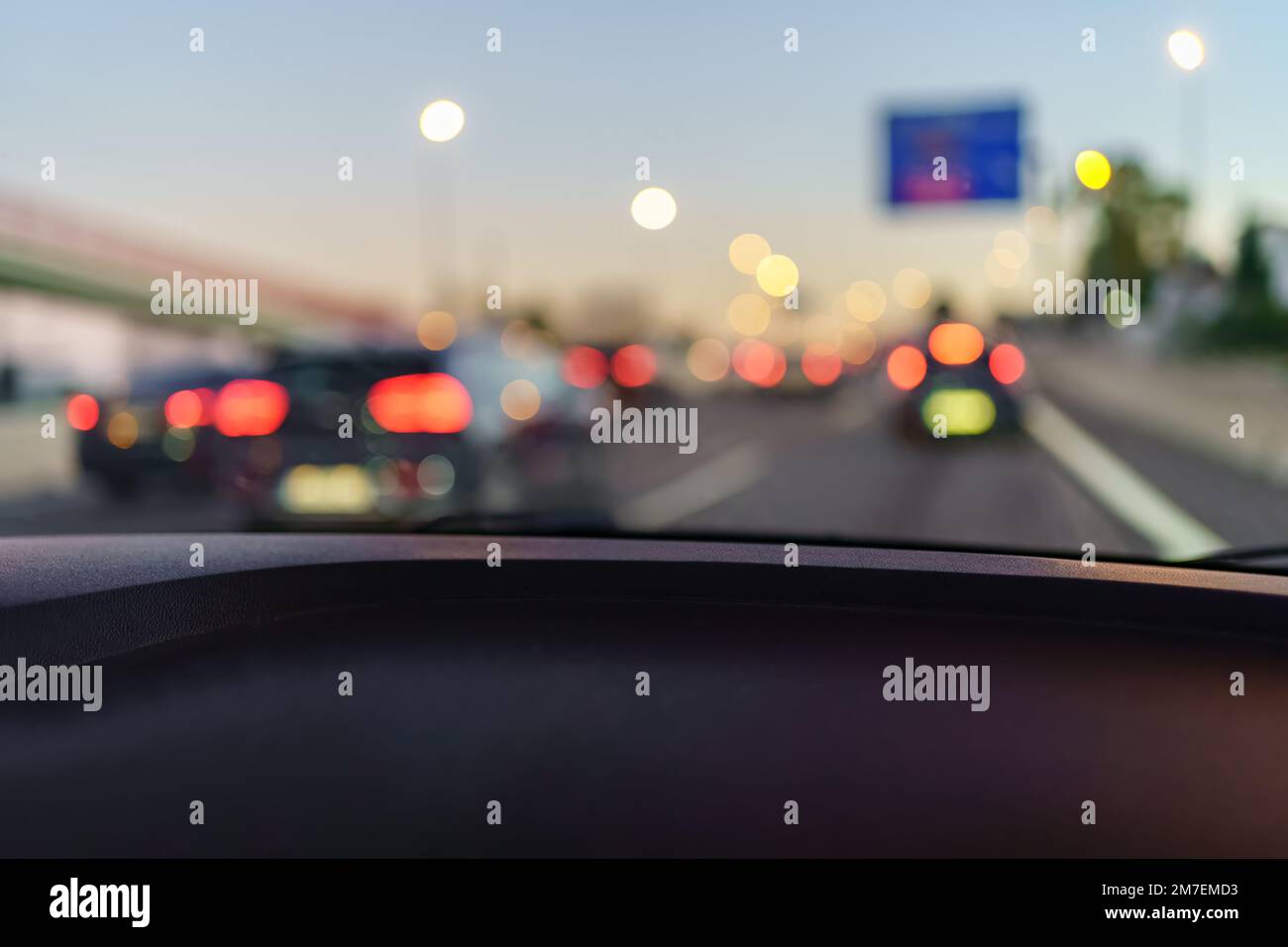 Car lights out of focus on the road as dusk gets in city, photo with ...